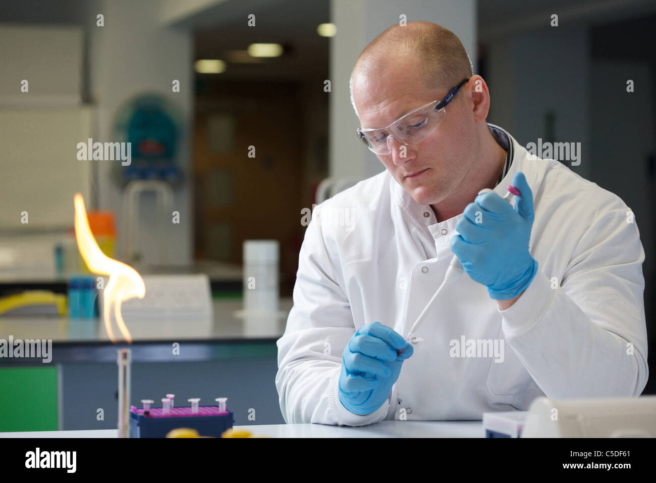 Wednesday 6th July 2011 Lab technician using a pipette at the Leeds ...
