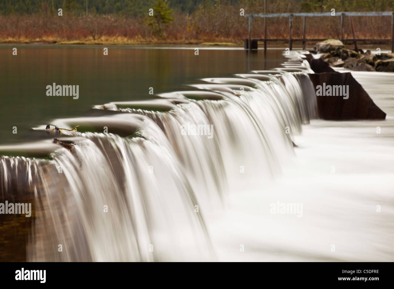 Long exposure of water flowing over the weir at Eyak Lake near Cordova ...