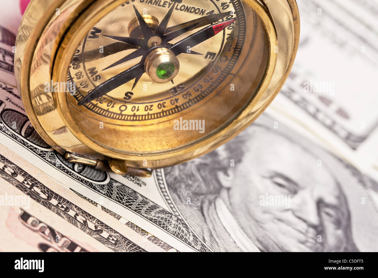 Dollar Currency notes and compass Stock Photo - Alamy