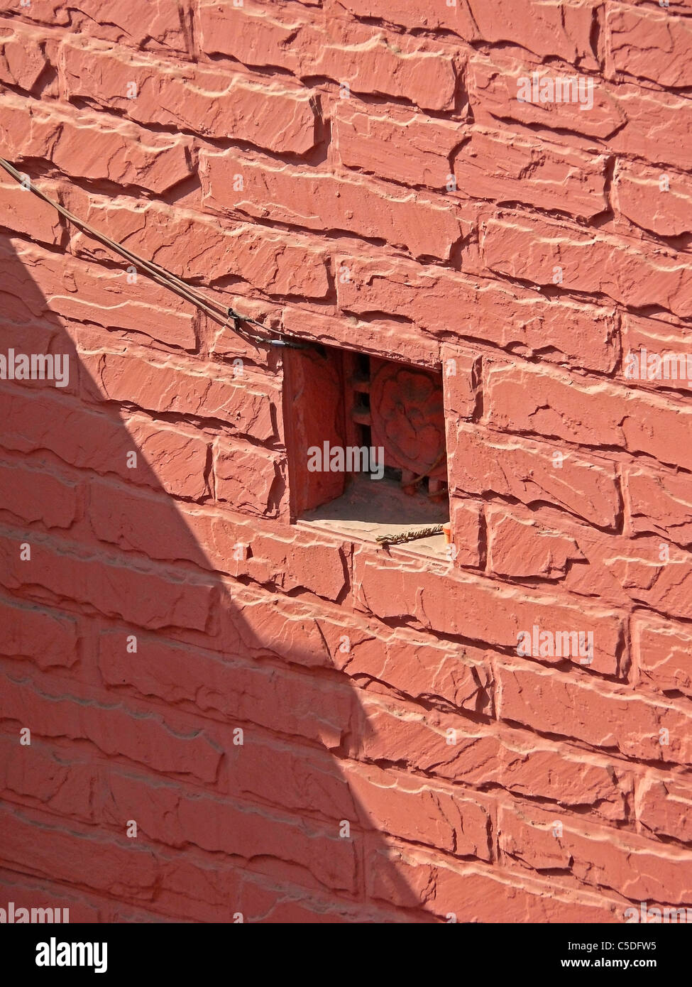 Stone Paved wall with a small opening Stock Photo - Alamy