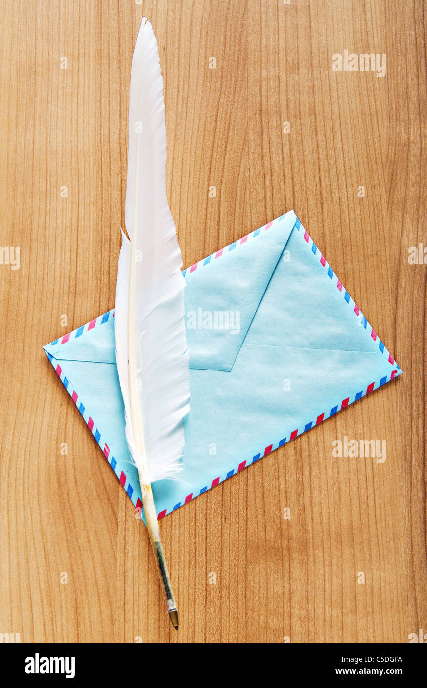Writing feather and envelope Stock Photo - Alamy