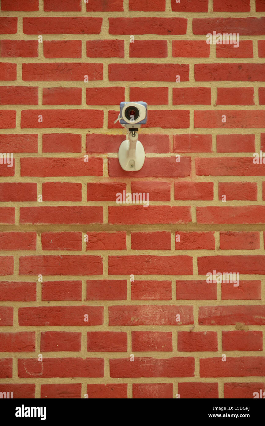 Brick wall with CCTV camera Stock Photo - Alamy