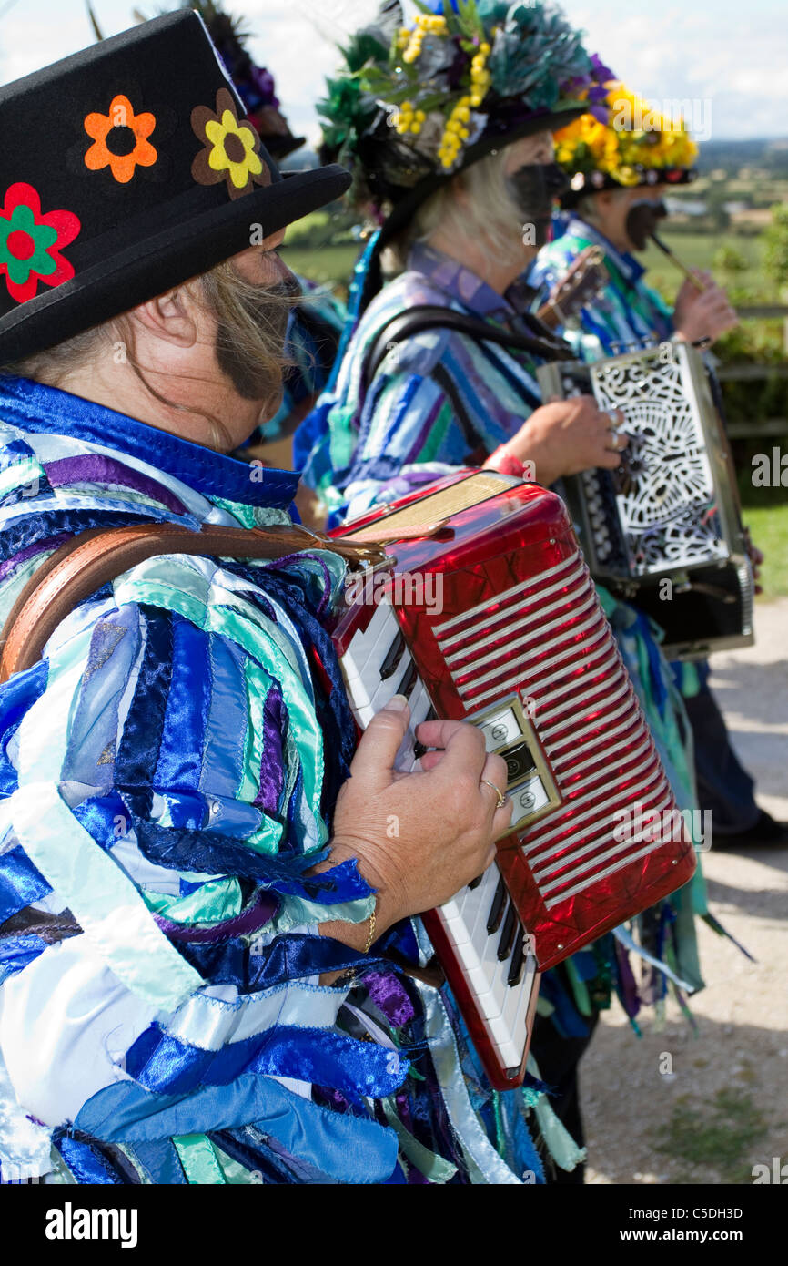 Exmoor Border Mixed Morris Dancers, black-faced, wearing long flowing ...