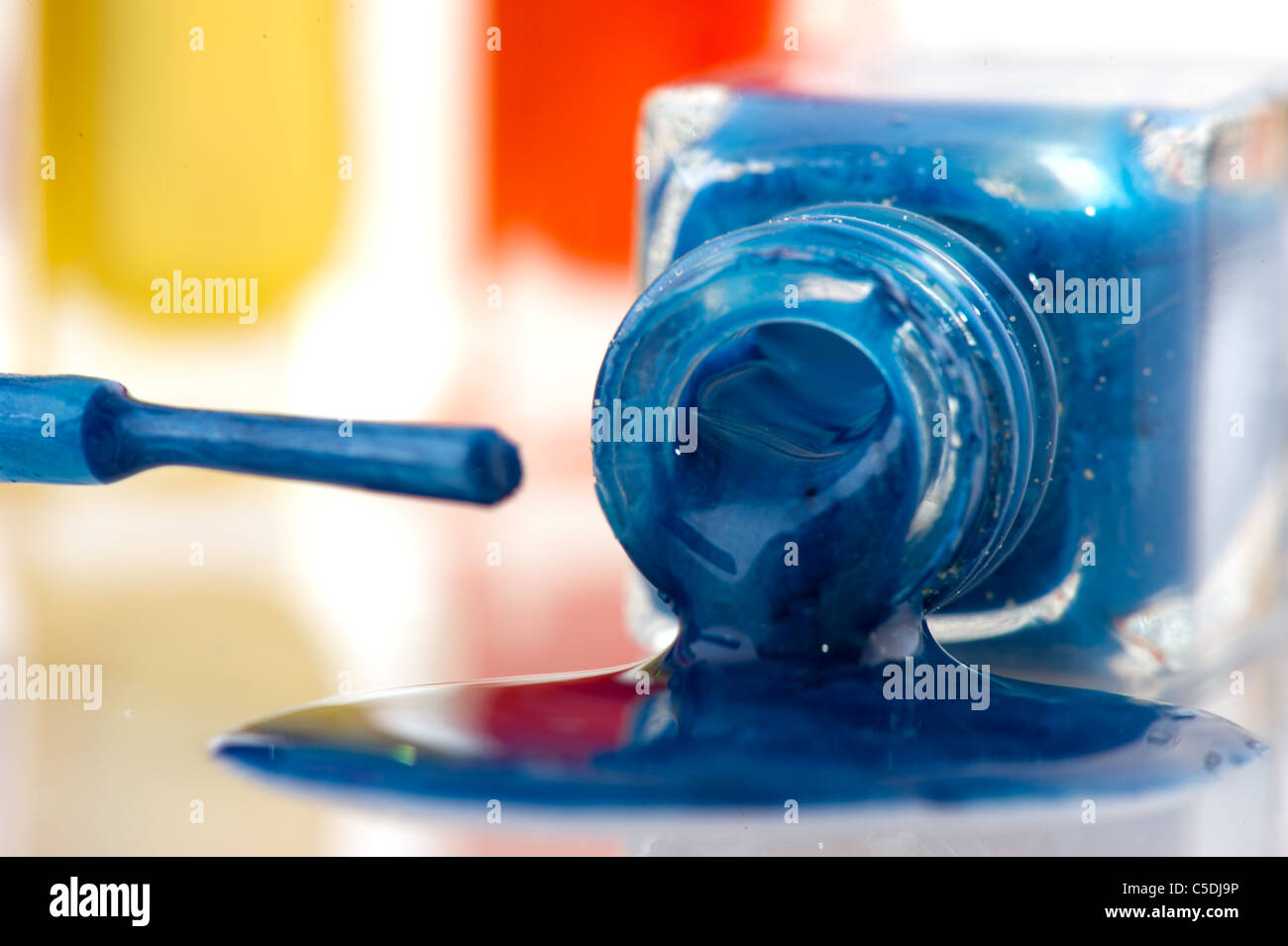 Fallen open bottle nail polish isolated over white Stock Photo - Alamy