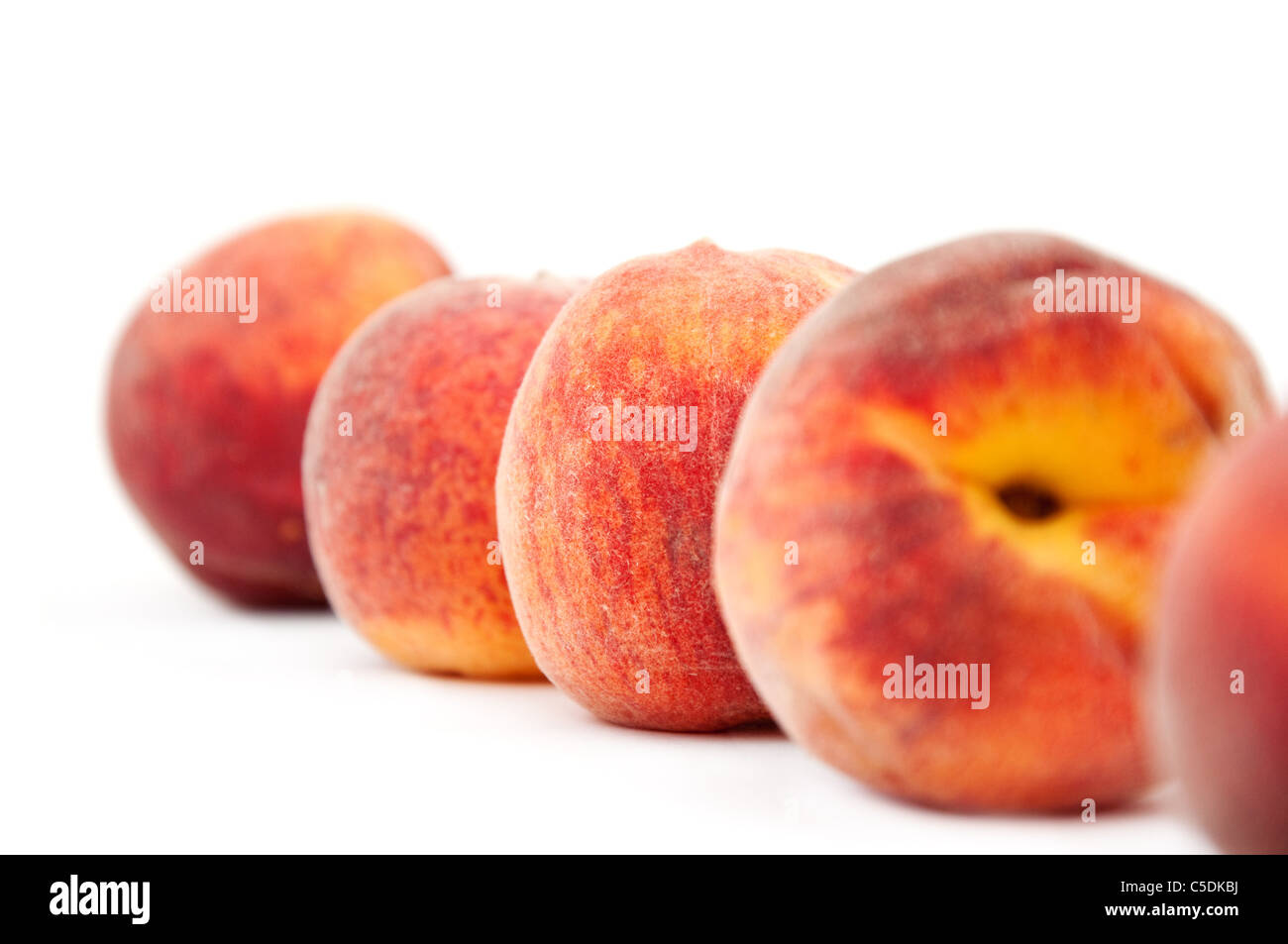 Few sweet peaches against a white background Stock Photo - Alamy