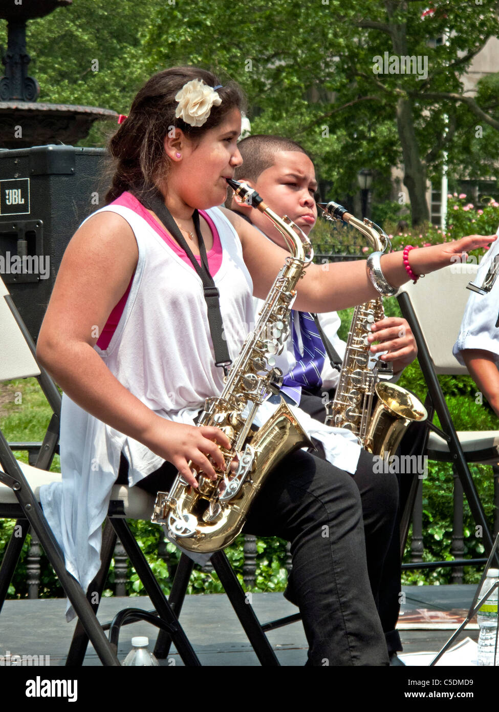 A band of elementary school musicians performs outdoors at Cadman Plaza ...