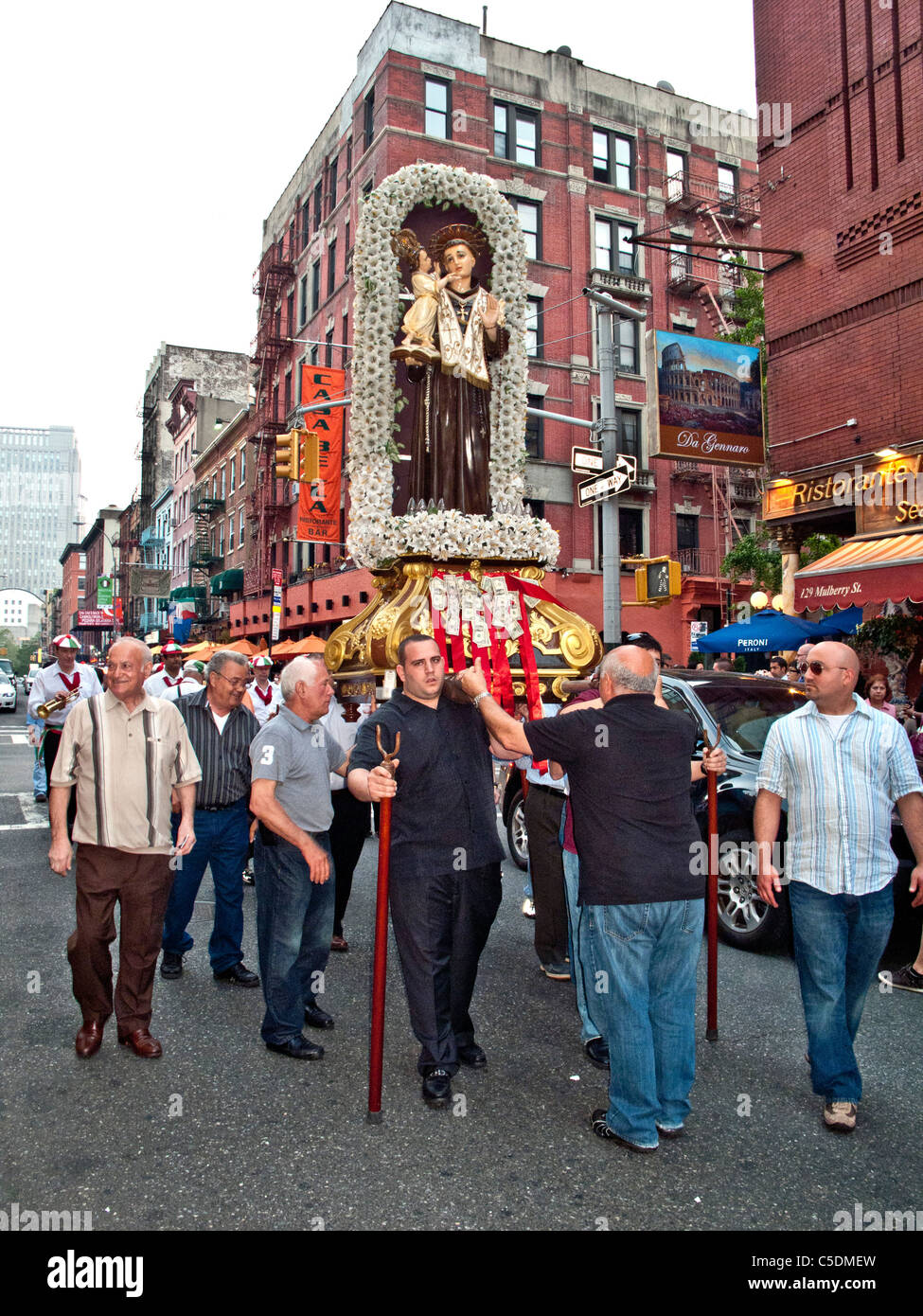 A procession for the Festival of St. Anthony marches through New York ...