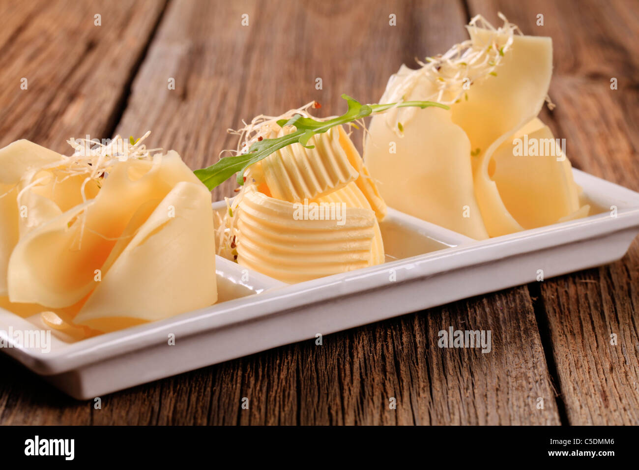 Thin slices of Swiss cheese and butter Stock Photo - Alamy
