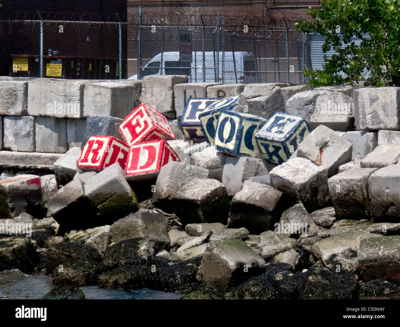 Lettered cement blocks spell out Red Hook on the beach in Louis ...