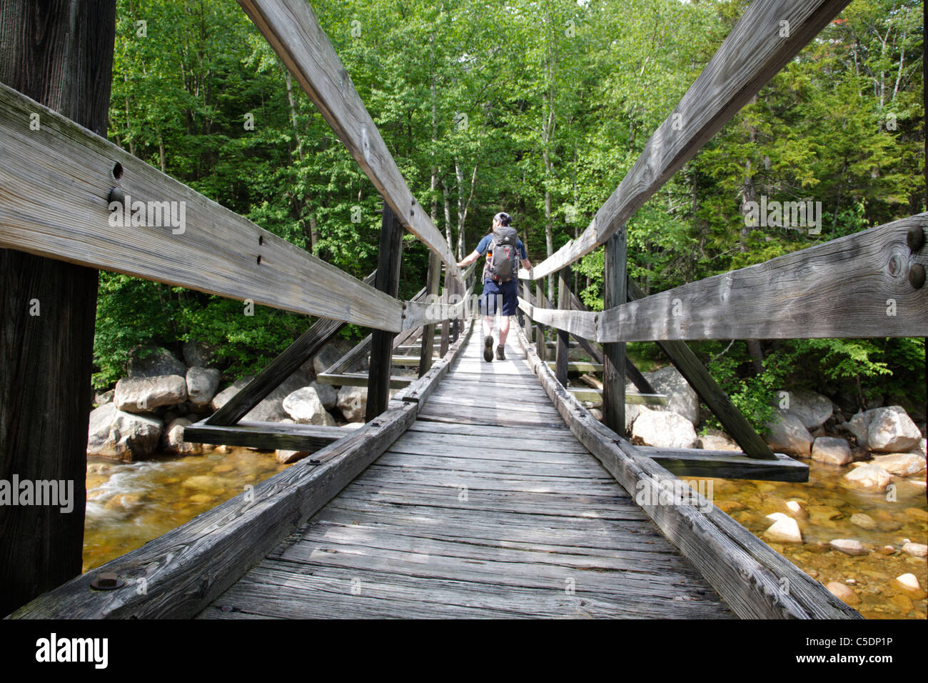 Pemigewasset Wilderness - A hiker on wooden footbridge, which crosses ...