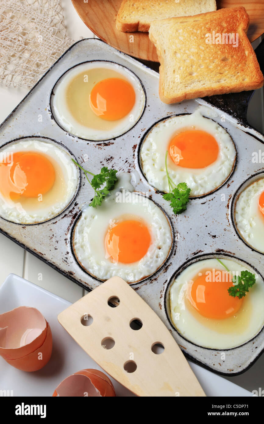 Fried eggs in a pan and toasted bread Stock Photo - Alamy