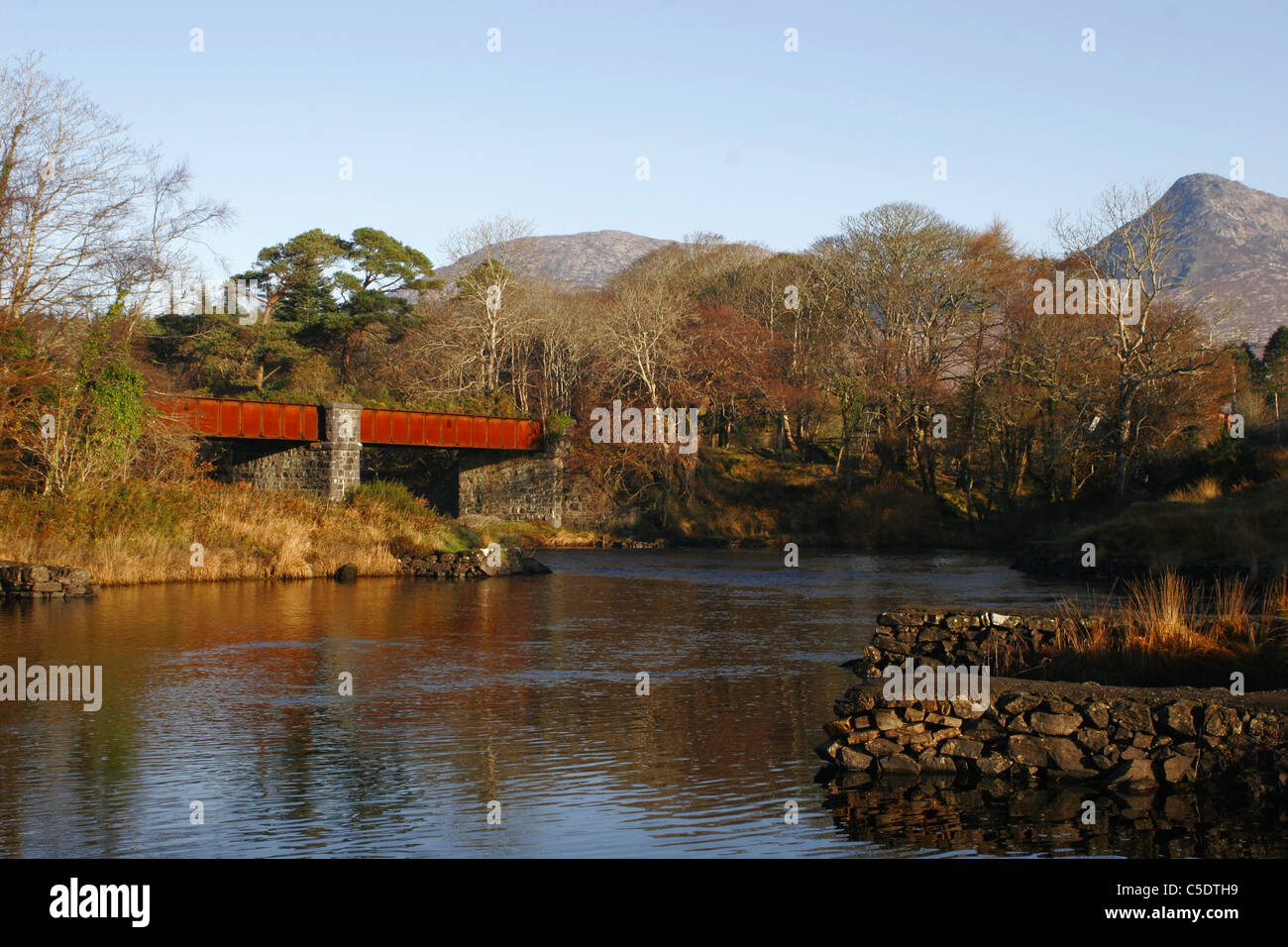 Disused railway bridge over the trout fishing river running through ...