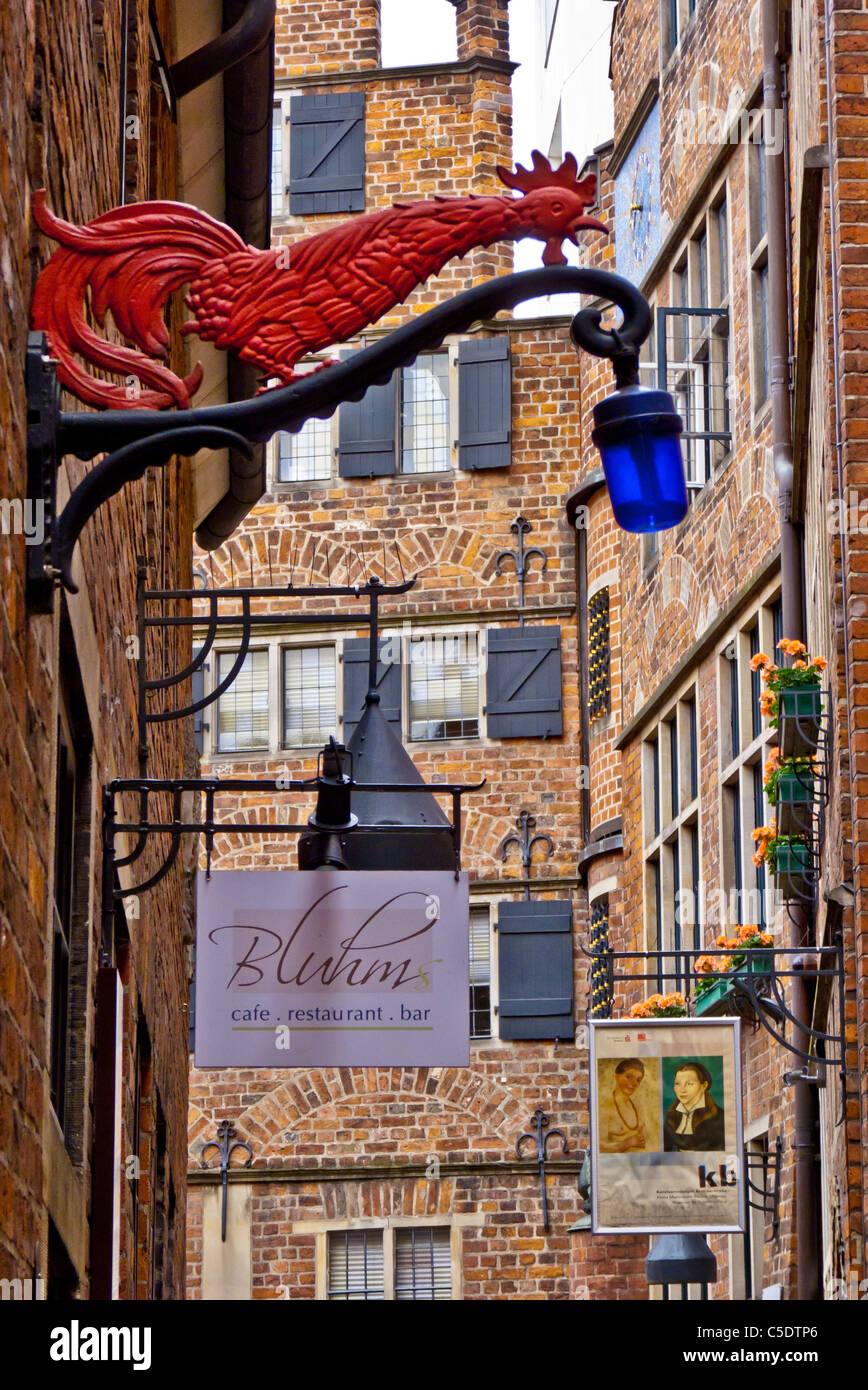 Wrought-iron traditional hanging signs in the Boettcherstraße - Bremen ...