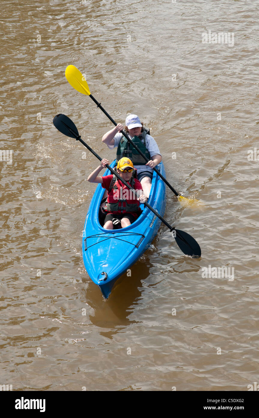 Peddling a kayak on smooth lake Stock Photo - Alamy