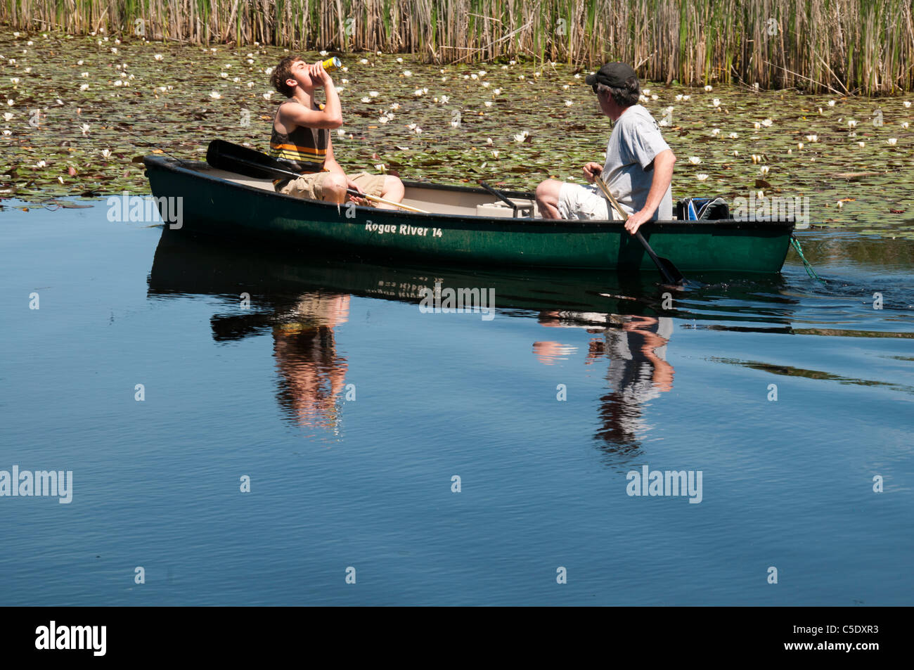 Men in canoe hi-res stock photography and images - Alamy