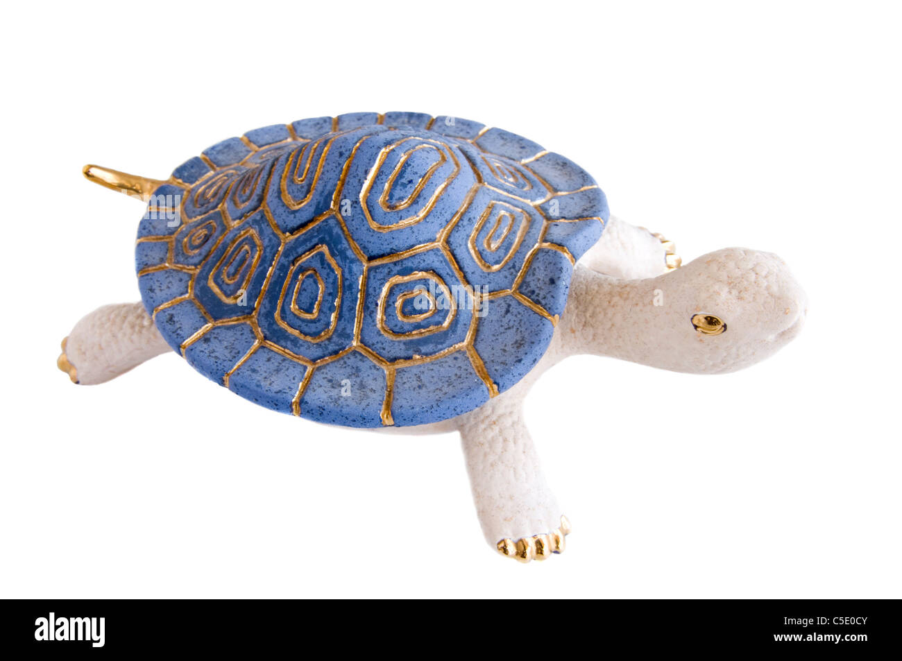 Blue and white painted clay turtle figurine against white background ...