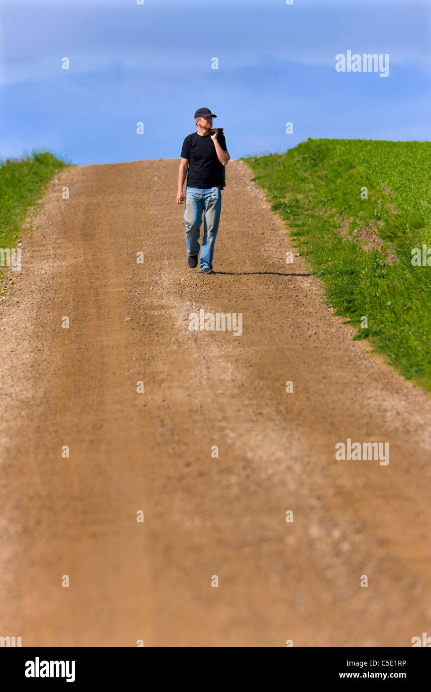 Man walking on country road hi-res stock photography and images - Alamy
