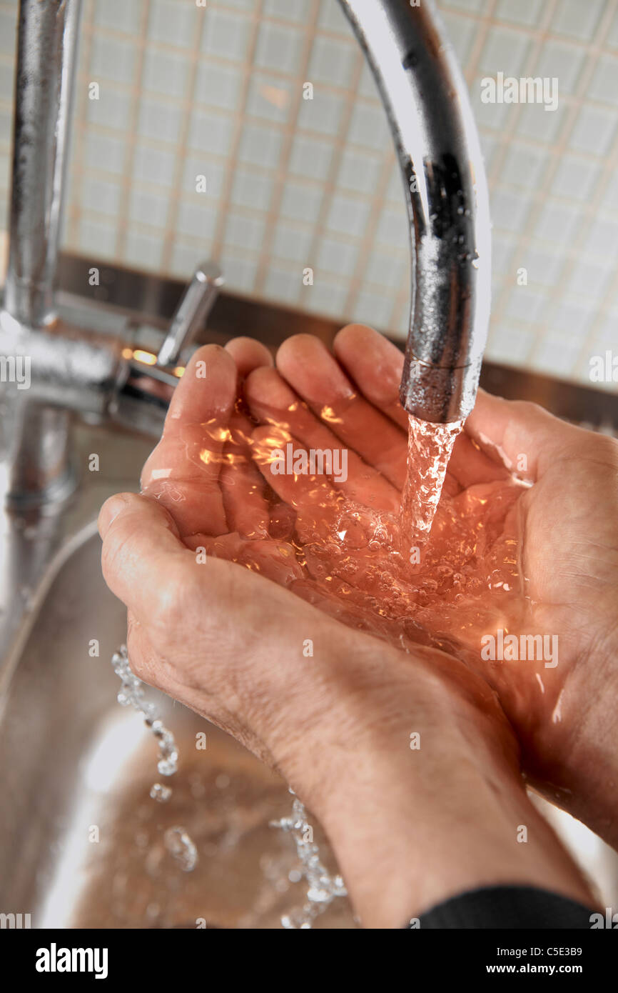 Cupped hands under tap hi-res stock photography and images - Alamy