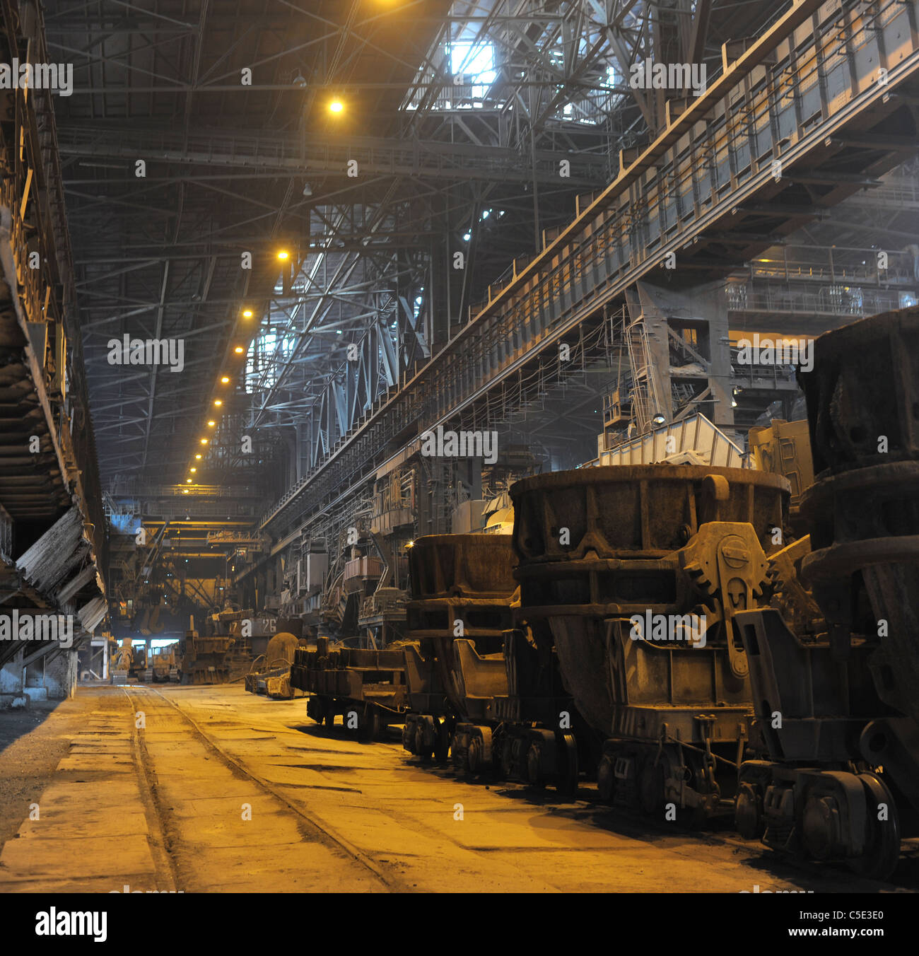 Shop of metallurgical industrial complex with ladles on a railway ...