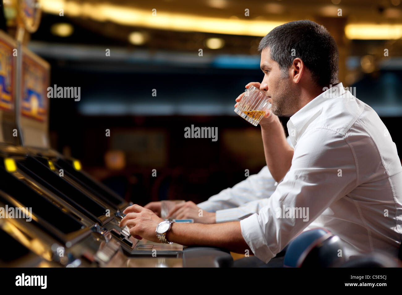 handsome man beeing concentrated in playing the slot machine Stock ...