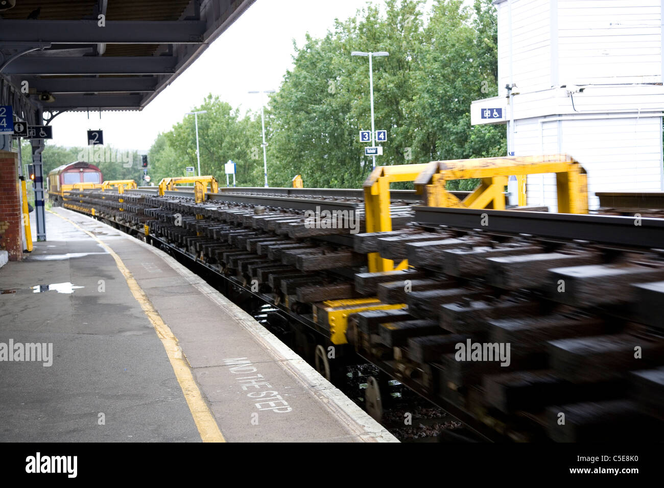Cargo train carrying tracks Stock Photo - Alamy