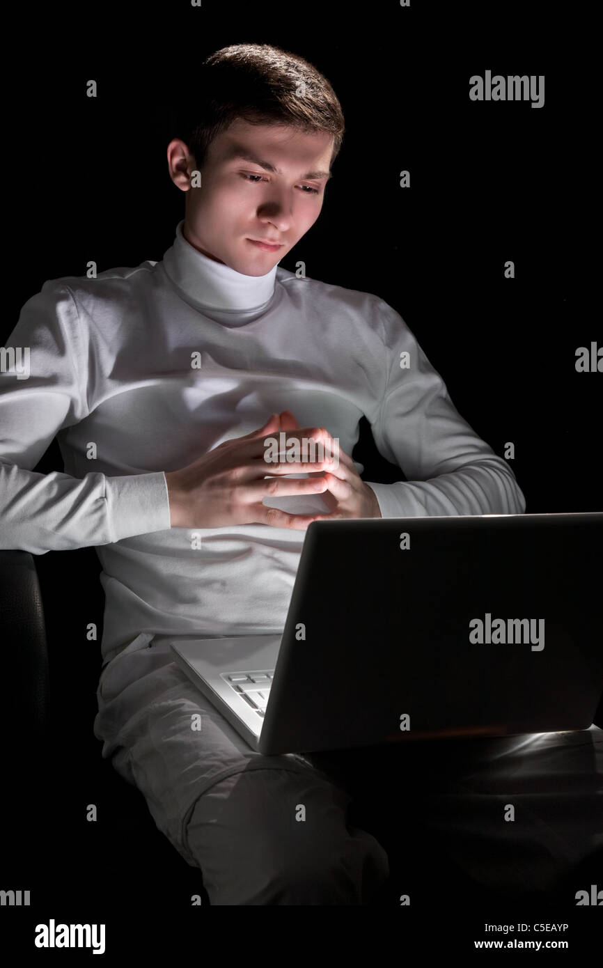 Young man in white with white laptop Stock Photo - Alamy