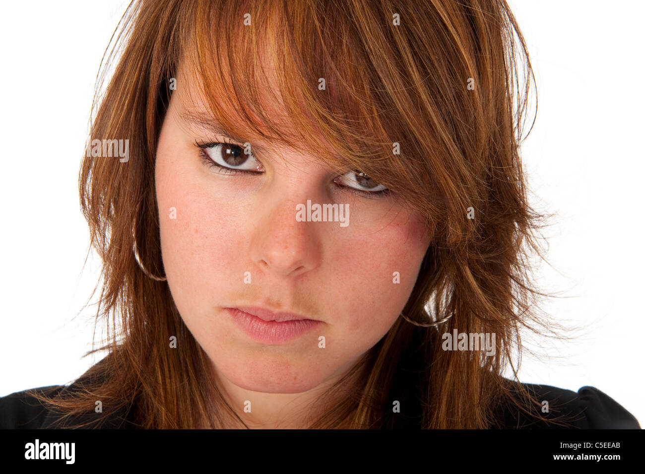 Portrait of an angry young girl on white Stock Photo - Alamy