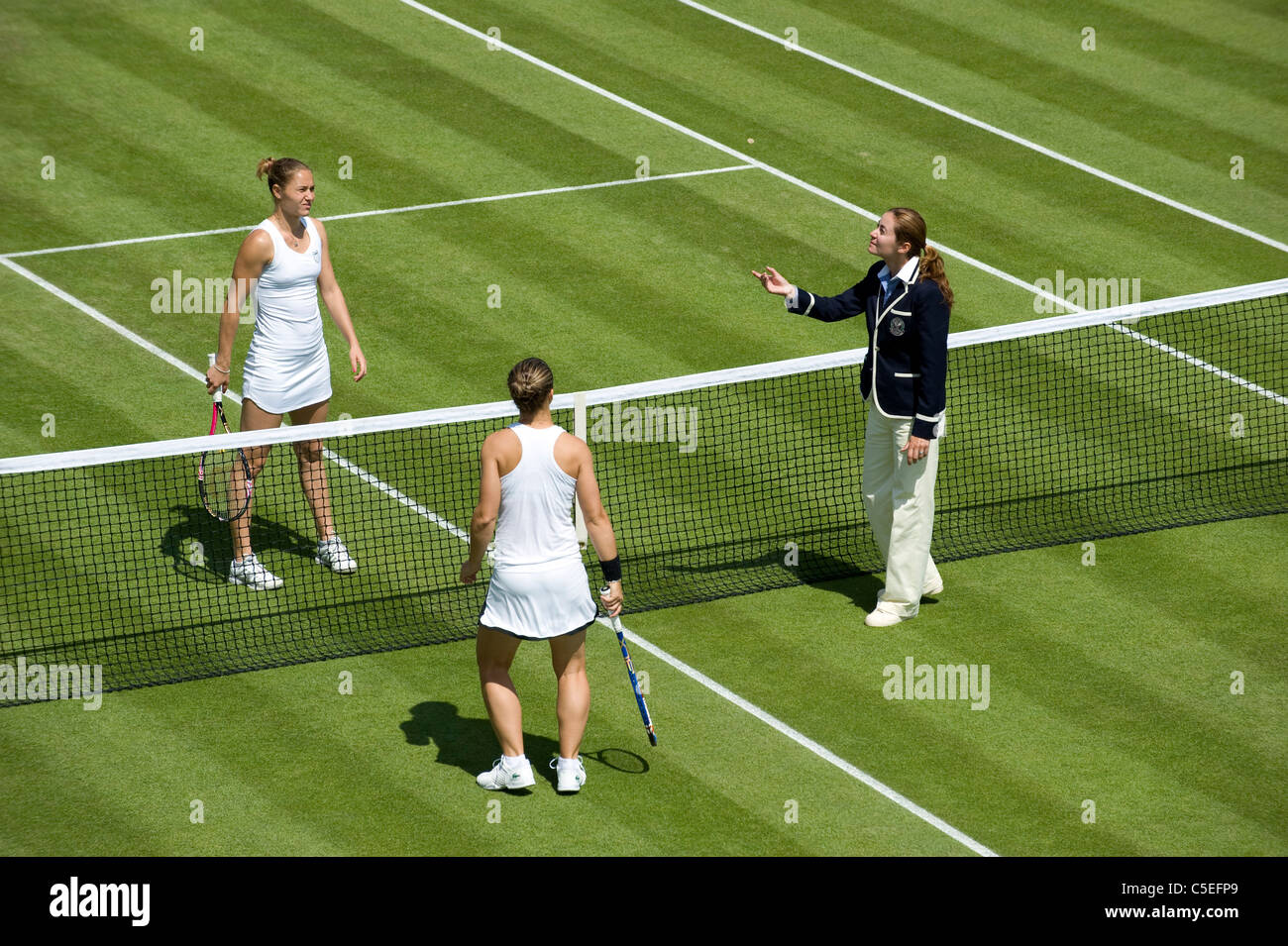 The coin toss by the umpire before a game on court 4 during the 2011 ...