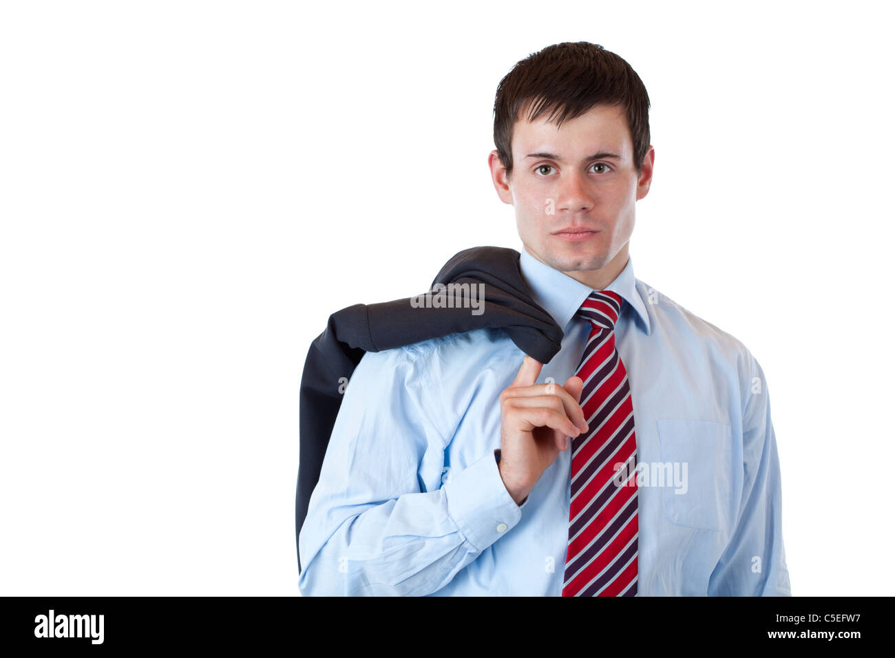 Young business man with jacket over shoulder looks seriously. Isolated ...