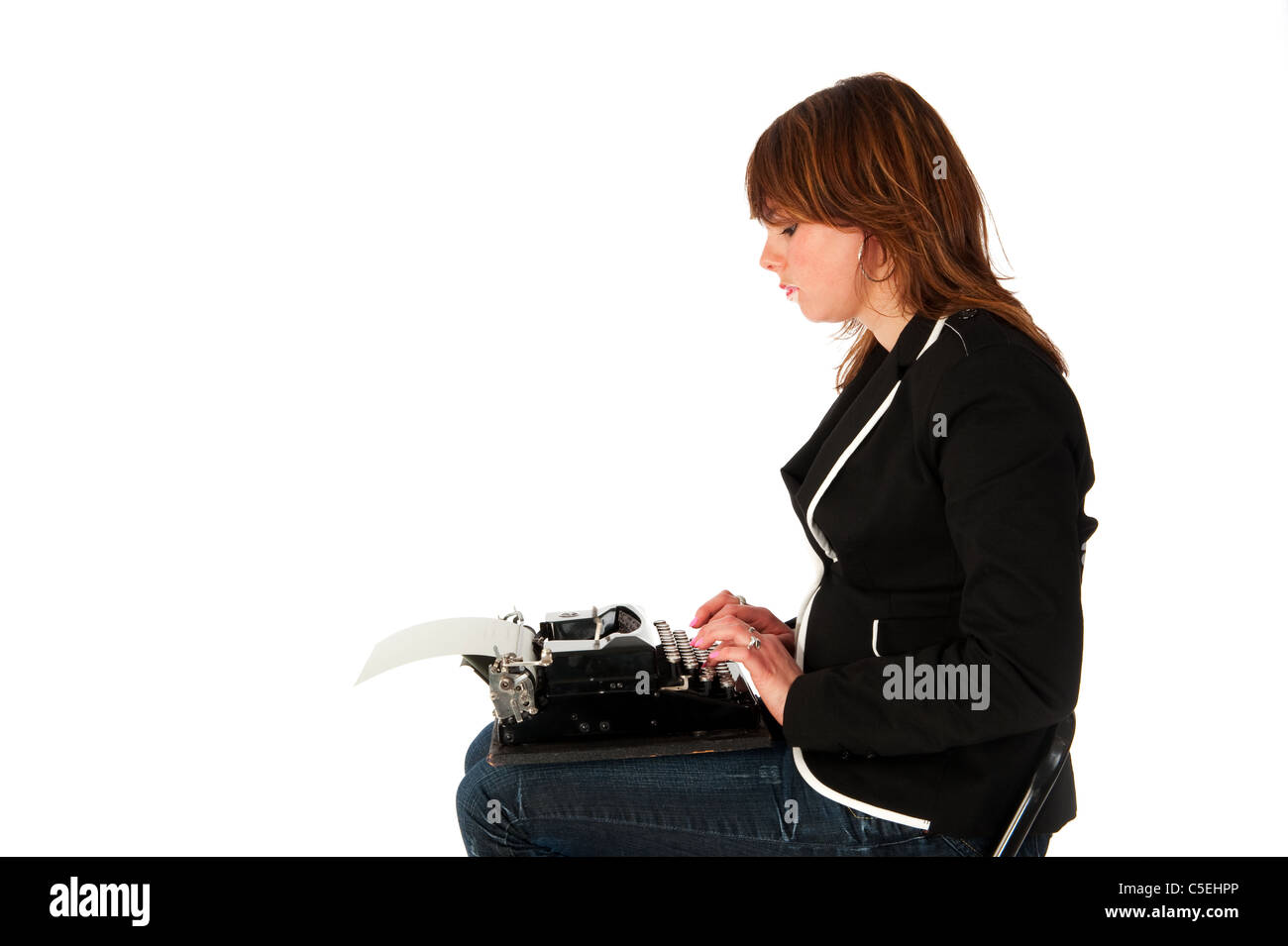 Young girl is typing at the old black typewriter Stock Photo - Alamy
