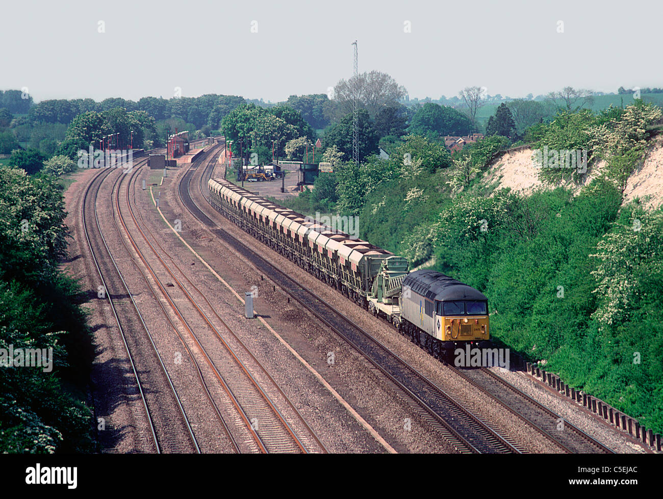 A class 56 diesel locomotive number 56065 heads east with a loaded ...