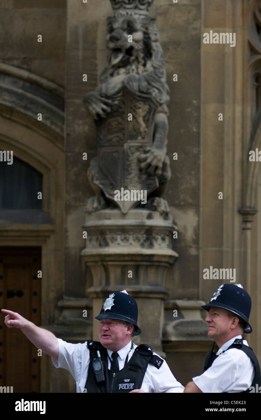 Two Metropolitan police officers talk on duty while guarding Britain's ...