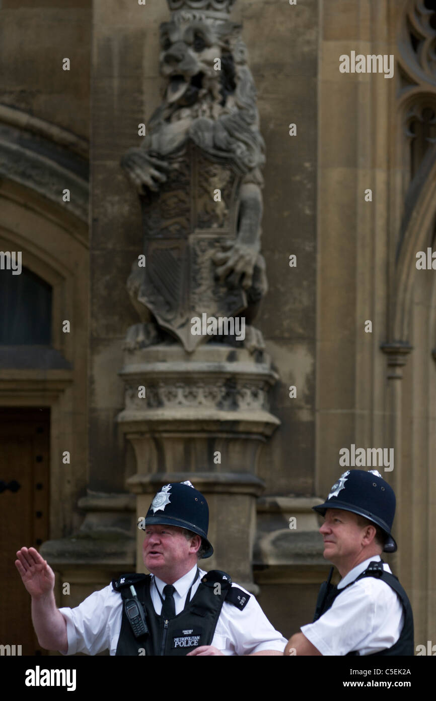 Two Metropolitan police officers talk on duty while guarding Britain's ...
