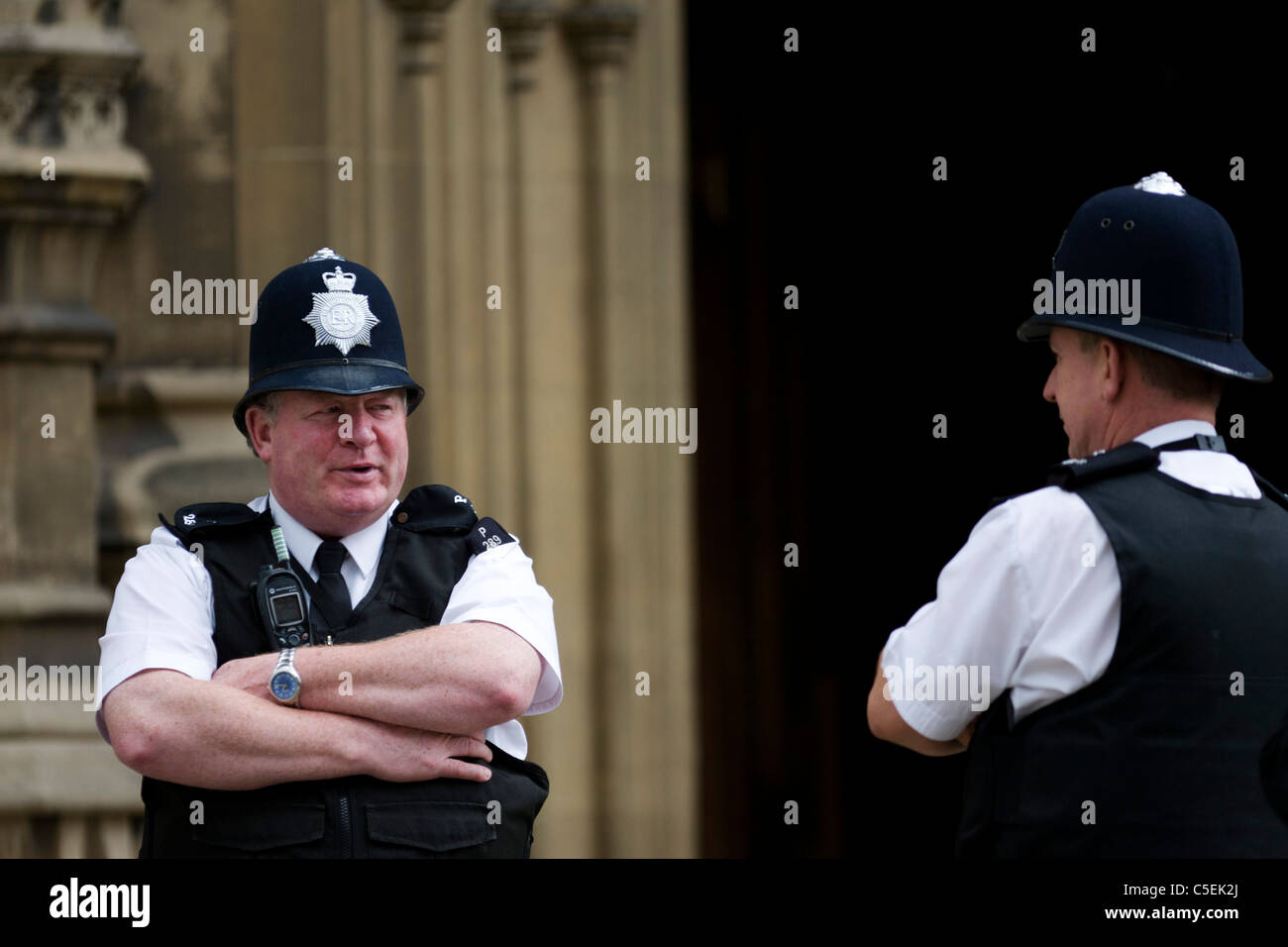 Two Metropolitan police officers talk on duty while guarding Britain's ...