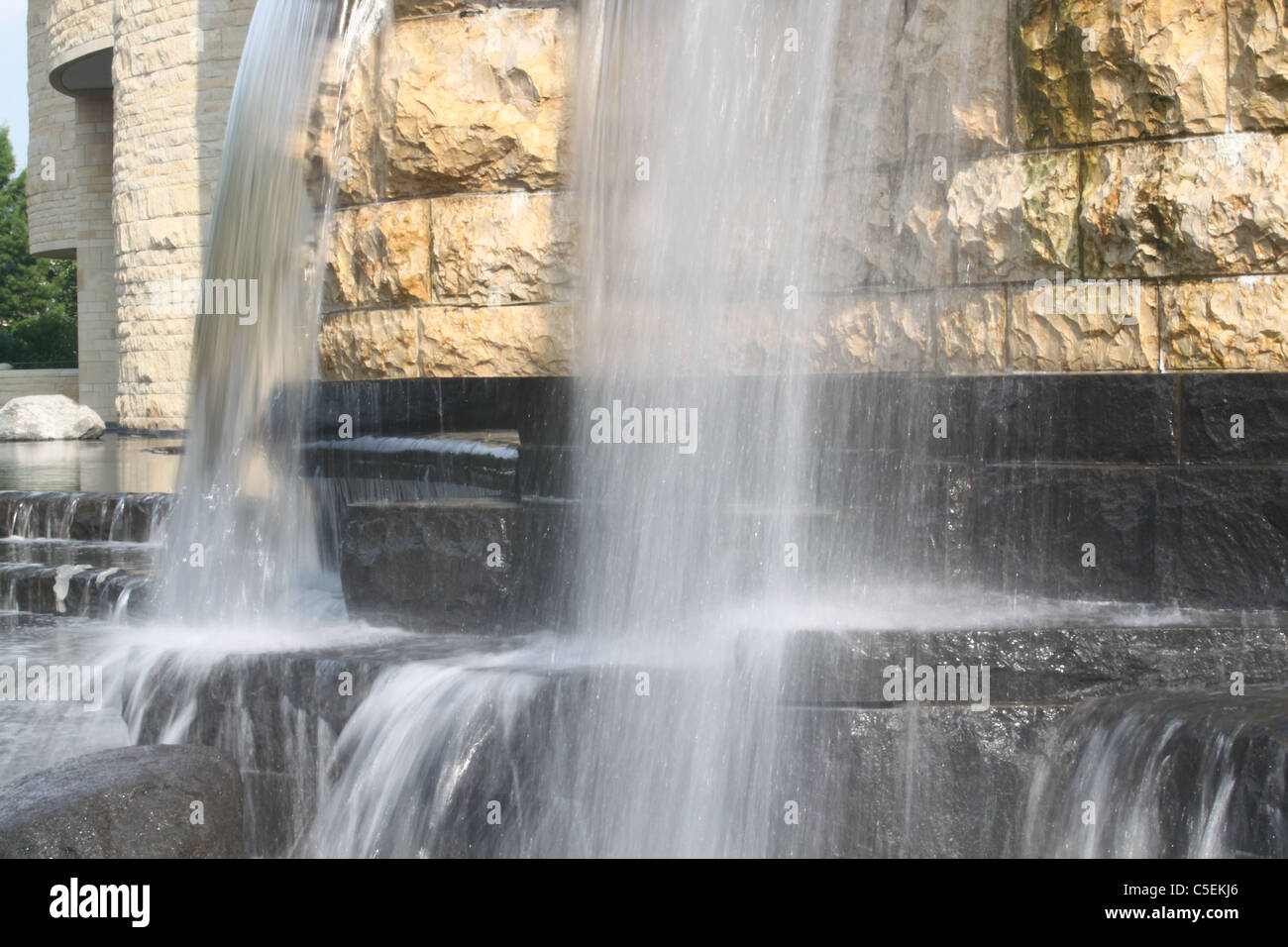 Waterfalls in front of stone wall Stock Photo - Alamy