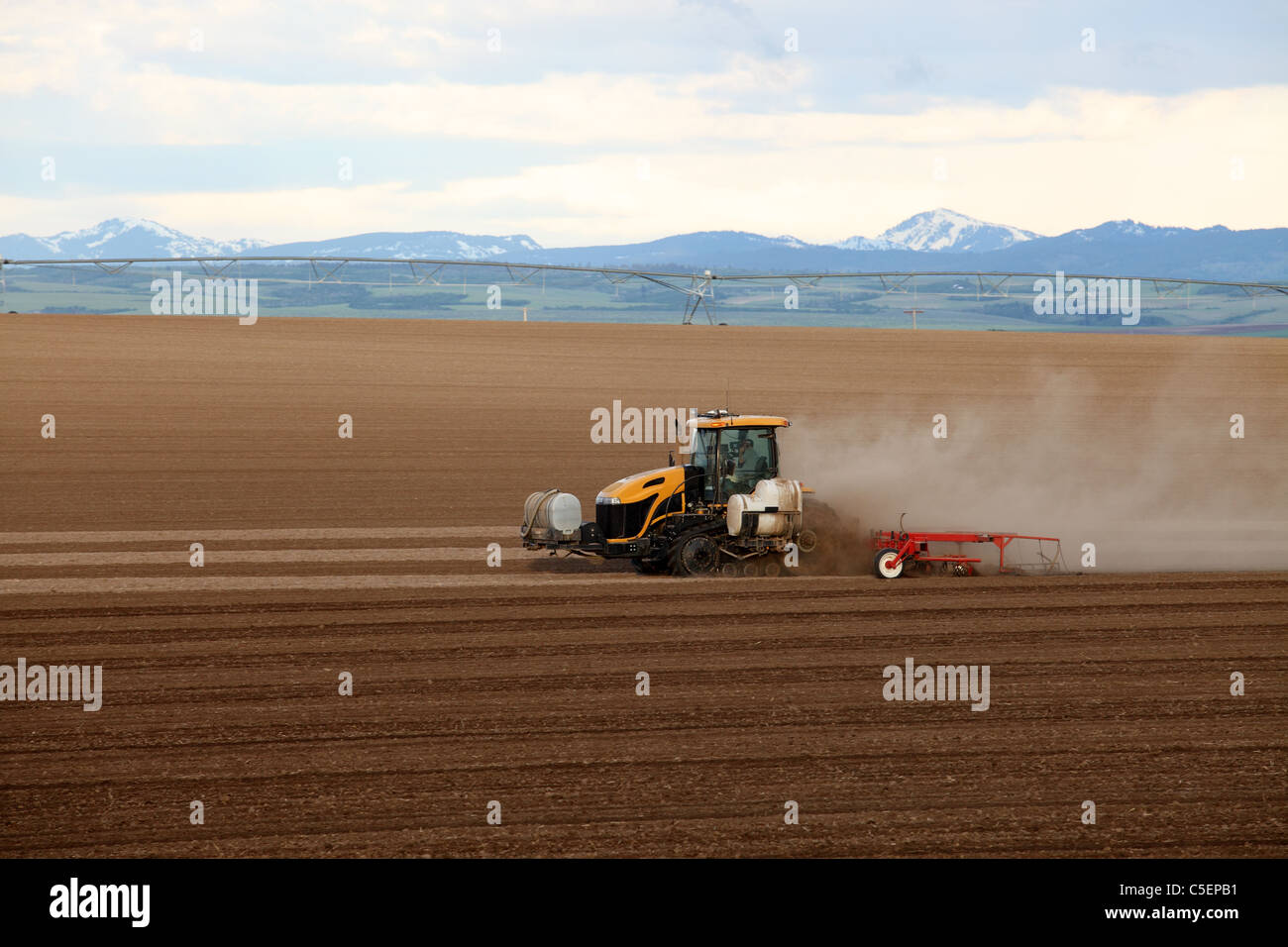 A tractor plowing a field Stock Photo - Alamy