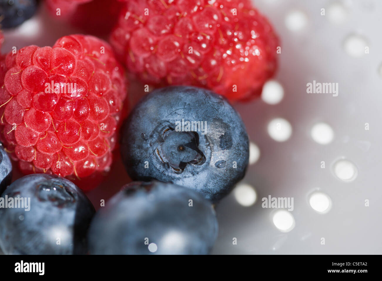 Fresh whole blueberries and raspberries Stock Photo - Alamy