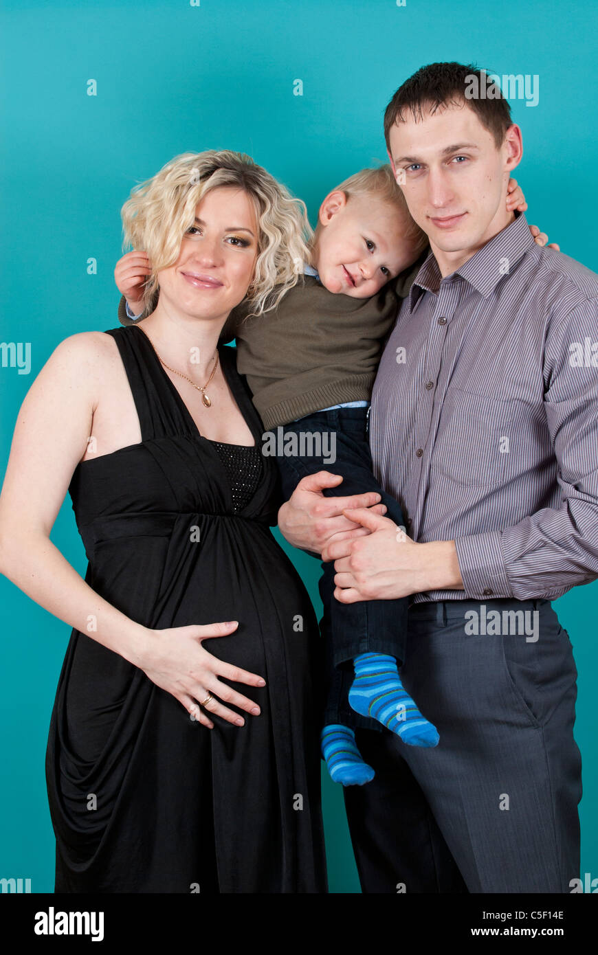 Portrait of happy pregnant woman with her partner and son smiling Stock ...