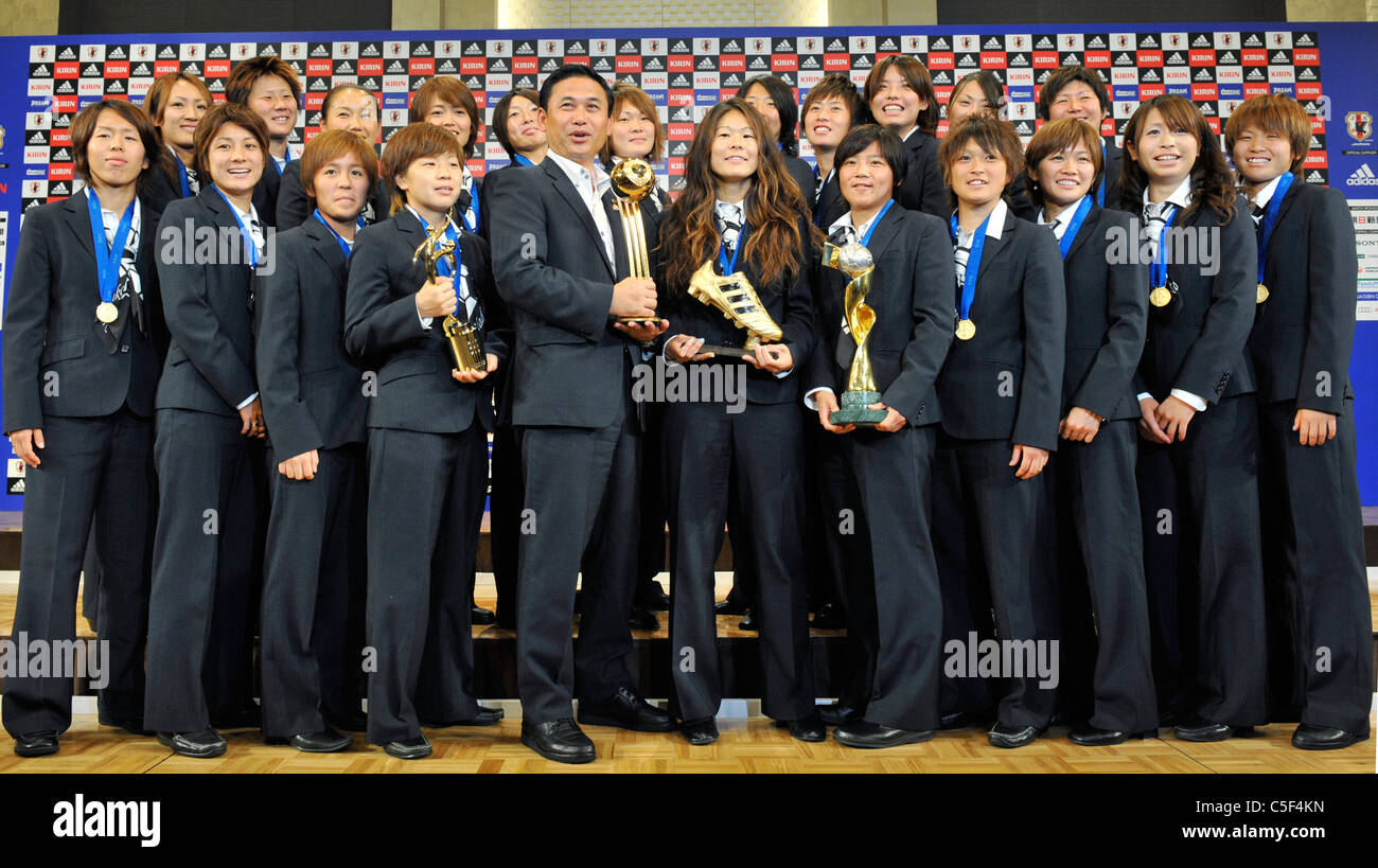 Japan team shows their medals and trophy during the return home press ...
