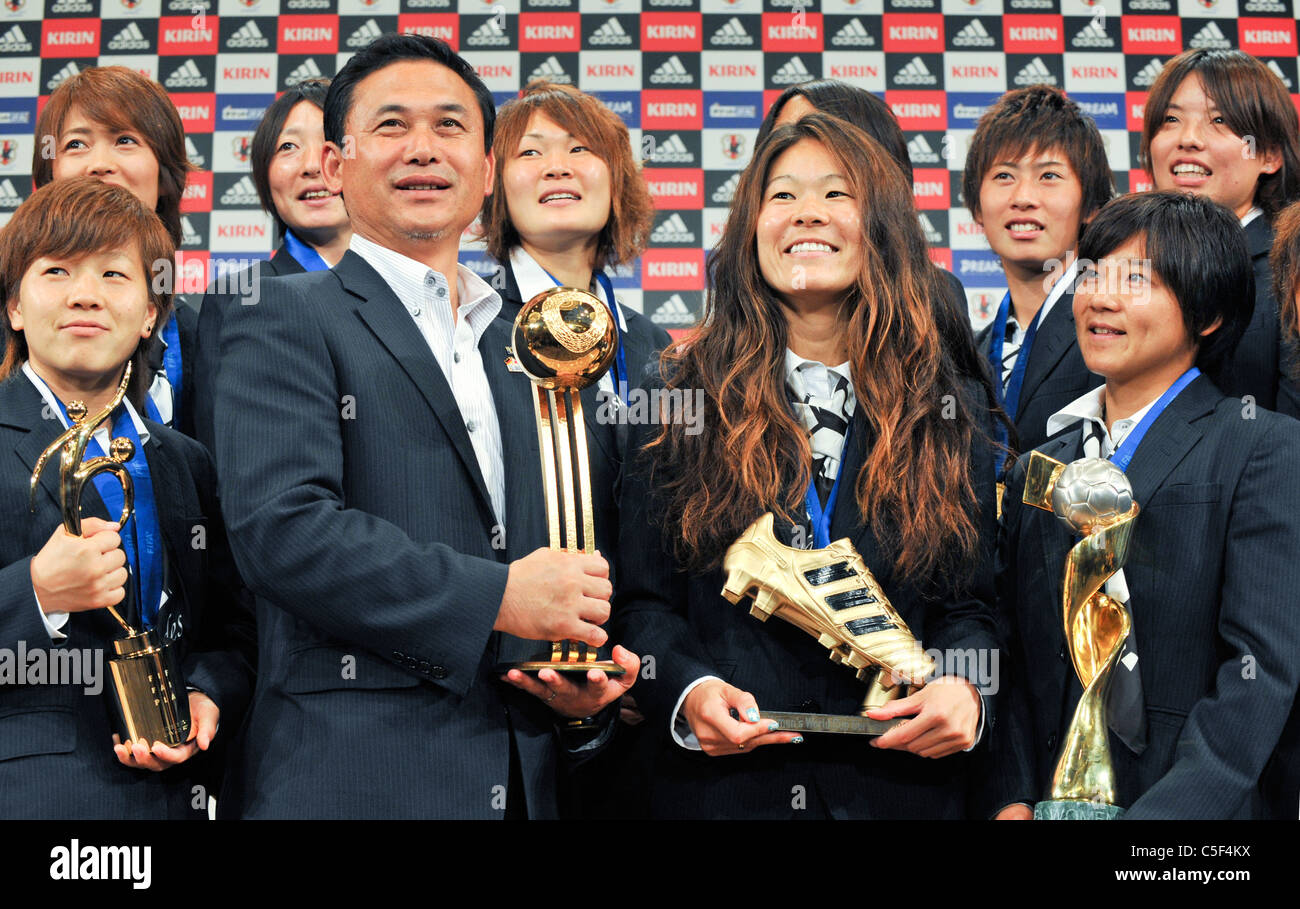 Japan team shows their medals and trophy during the return home press ...