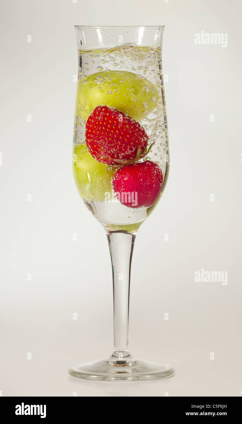 fruits and sparkling water in a champagne glass Stock Photo - Alamy