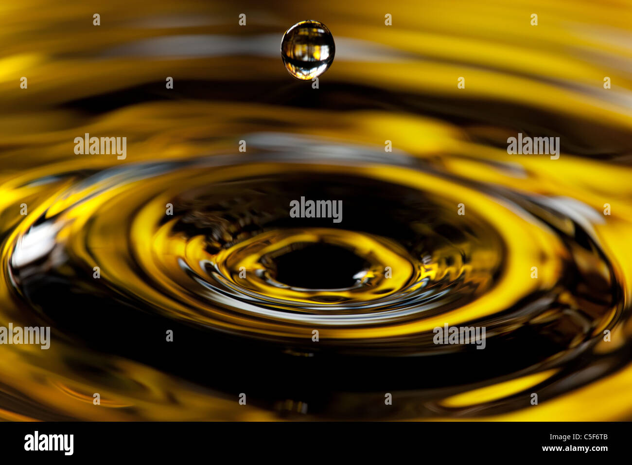 a golden drop of water Stock Photo - Alamy