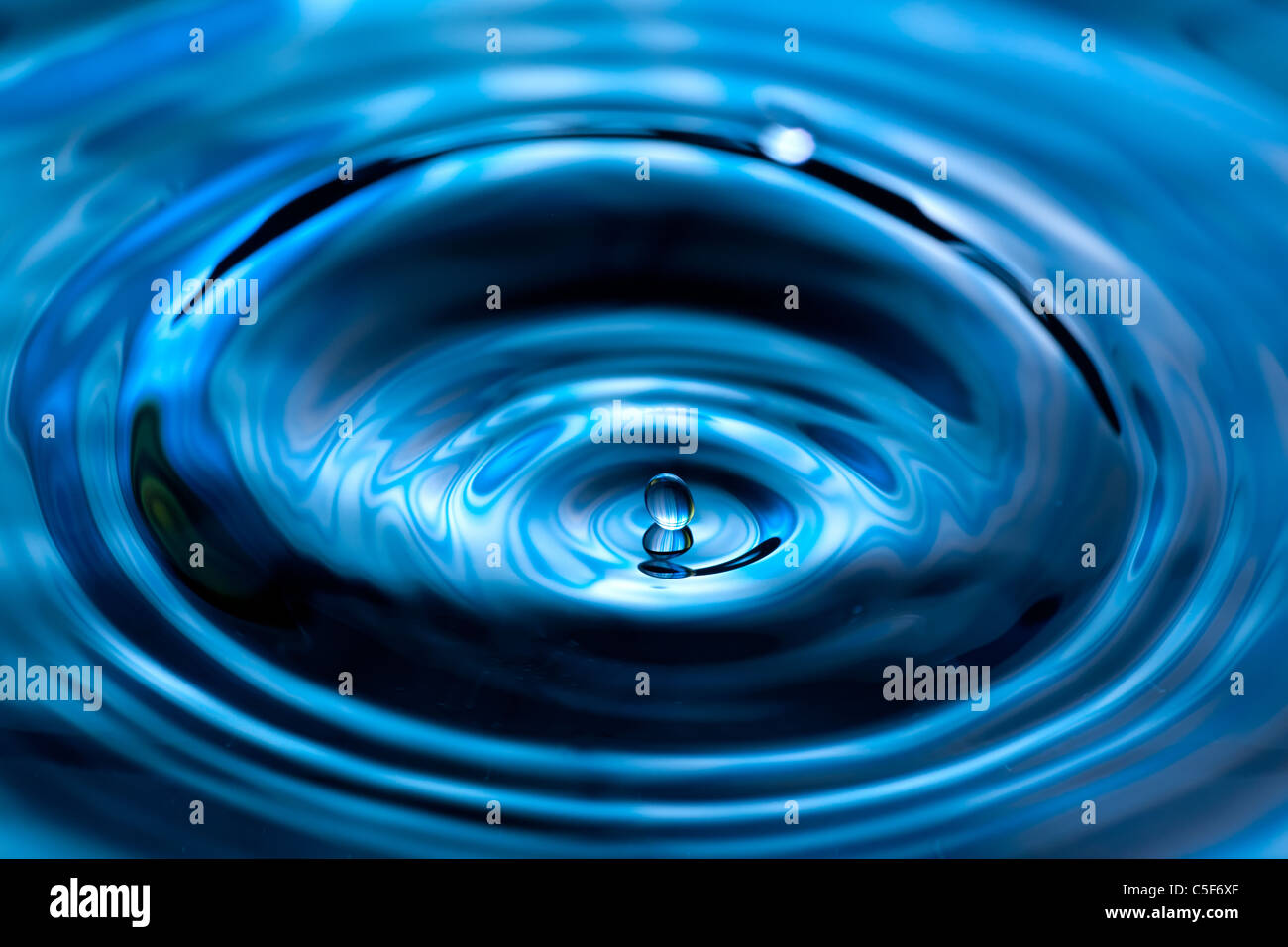 a drop just touching the surface of the water Stock Photo - Alamy