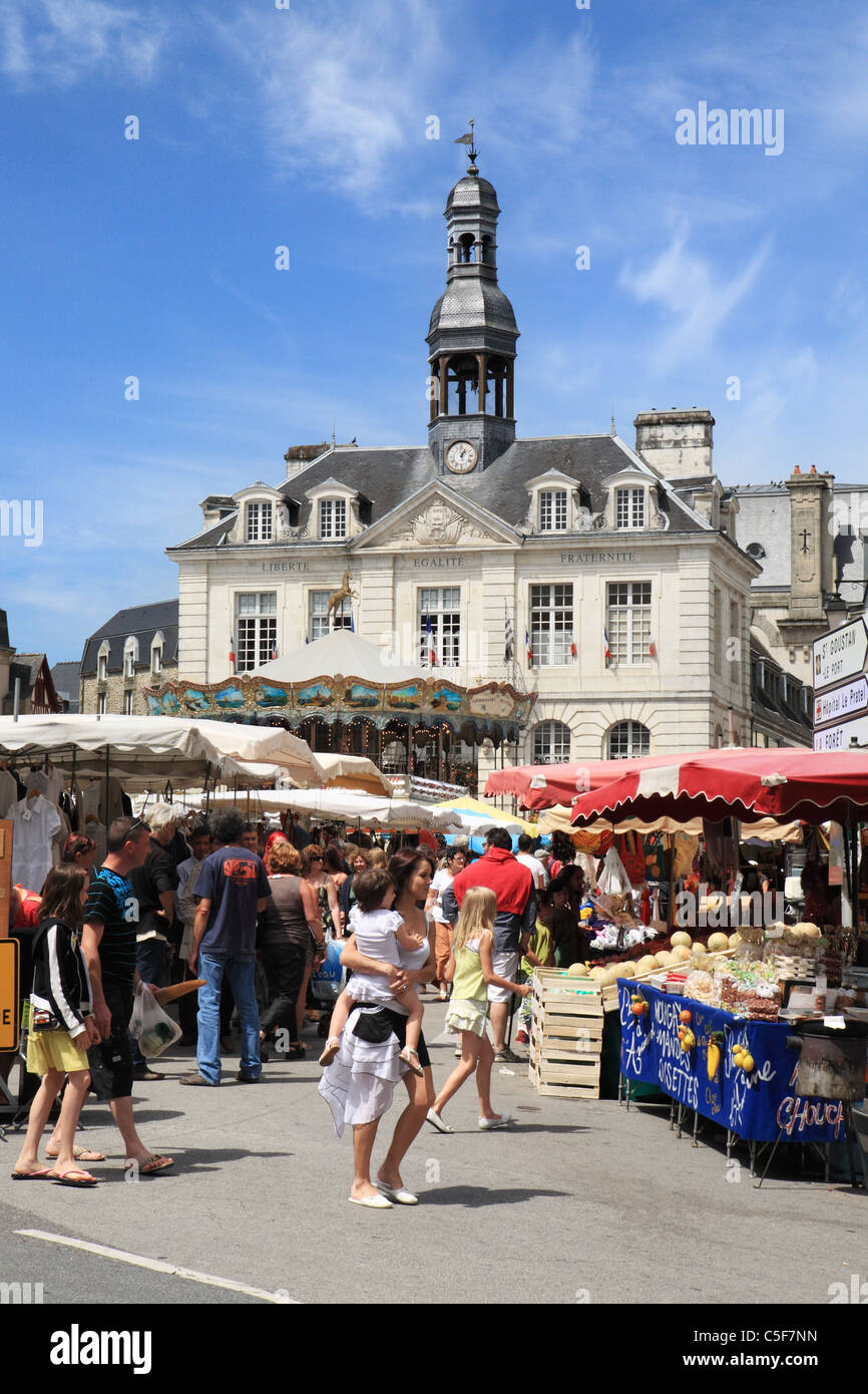 A young woman carrying a child before Auray market in Brittany, France ...