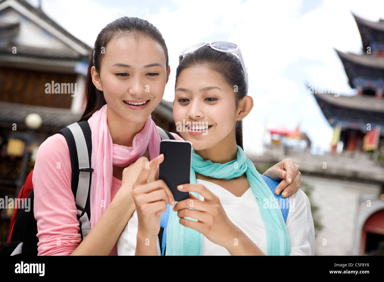 Young women using cellphone Stock Photo - Alamy