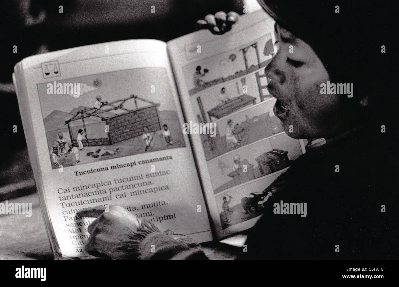 ECUADOR. Native boy learning Quechua language from textbook in a school ...