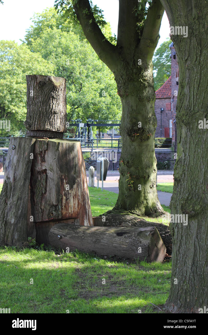 a tree figure sitting next to two normal standing trees , conceptual ...