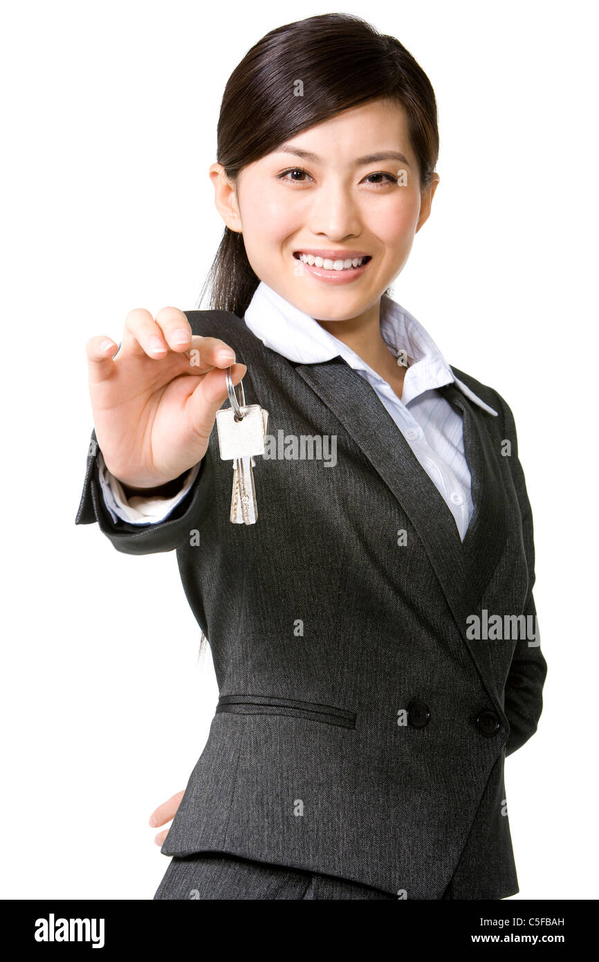 Young woman holding keys Stock Photo - Alamy