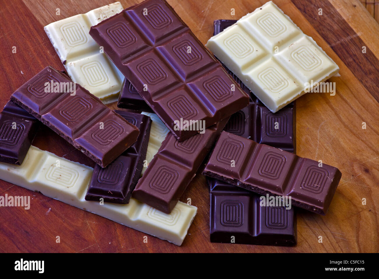 several pieces of chocolate in flavors whole milk, white chocolate and ...
