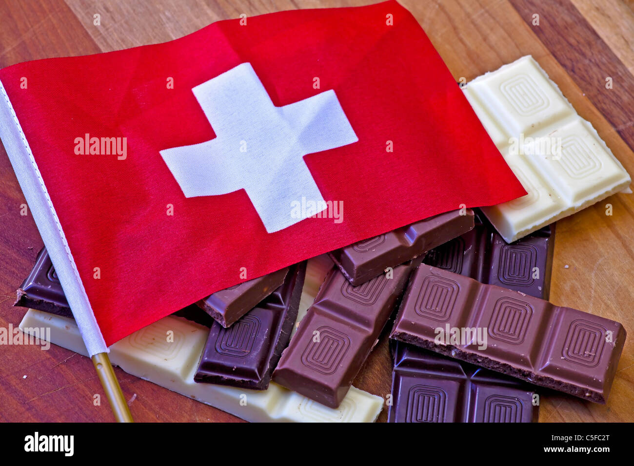 several pieces of chocolate with a Swiss flag Stock Photo - Alamy
